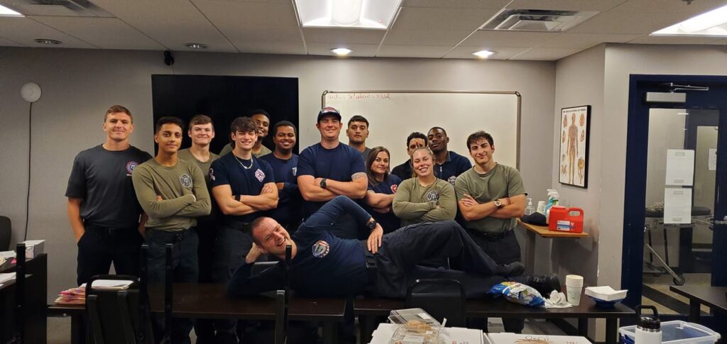 Group of firefighters posing in a classroom. | eei